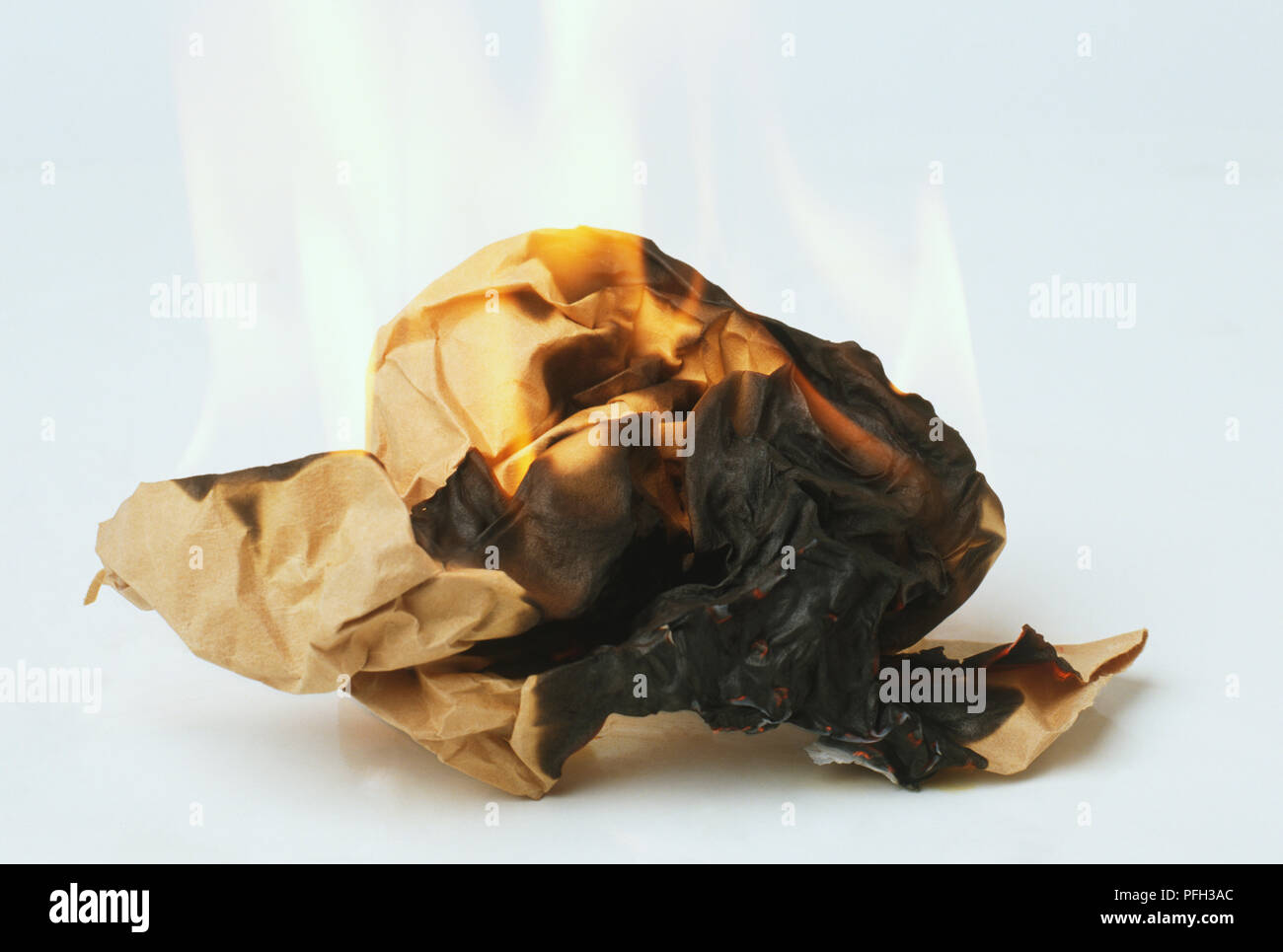 Crumpled brown paper burning, side view Stock Photo - Alamy