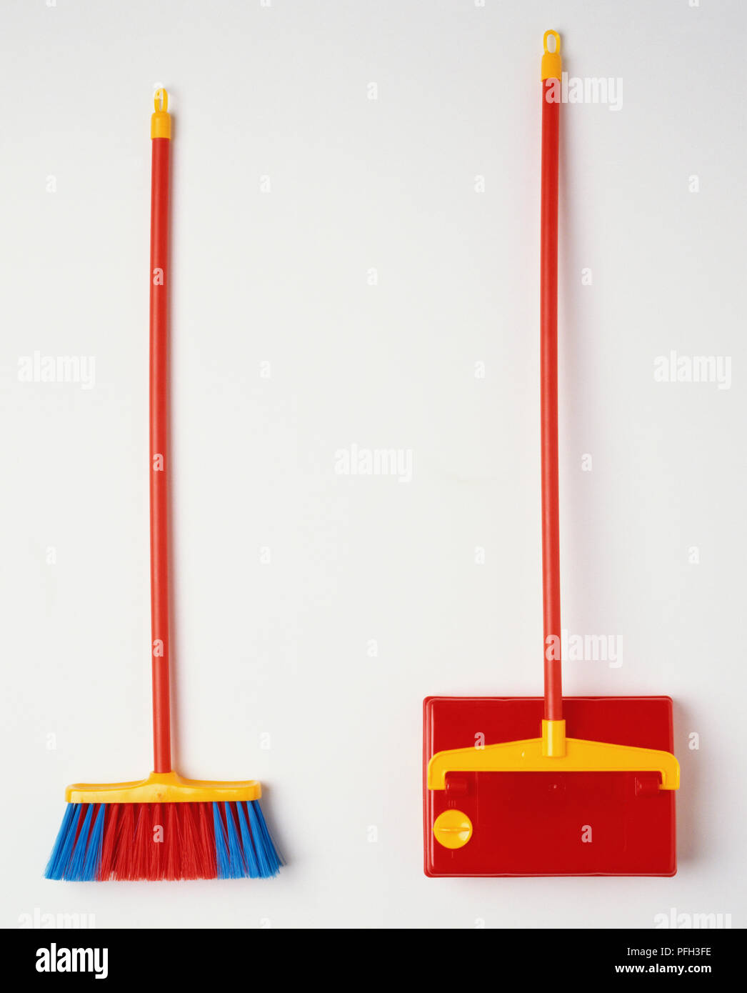 Two colourful brooms Stock Photo - Alamy