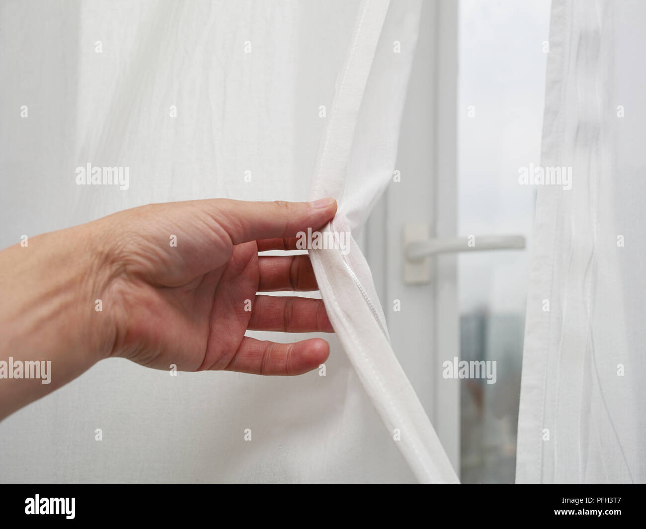 Male hand opening a curtain on the window, indoor closeup Stock Photo ...