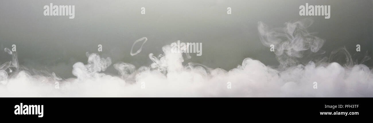 Dry ice swirling and floating in the air Stock Photo - Alamy