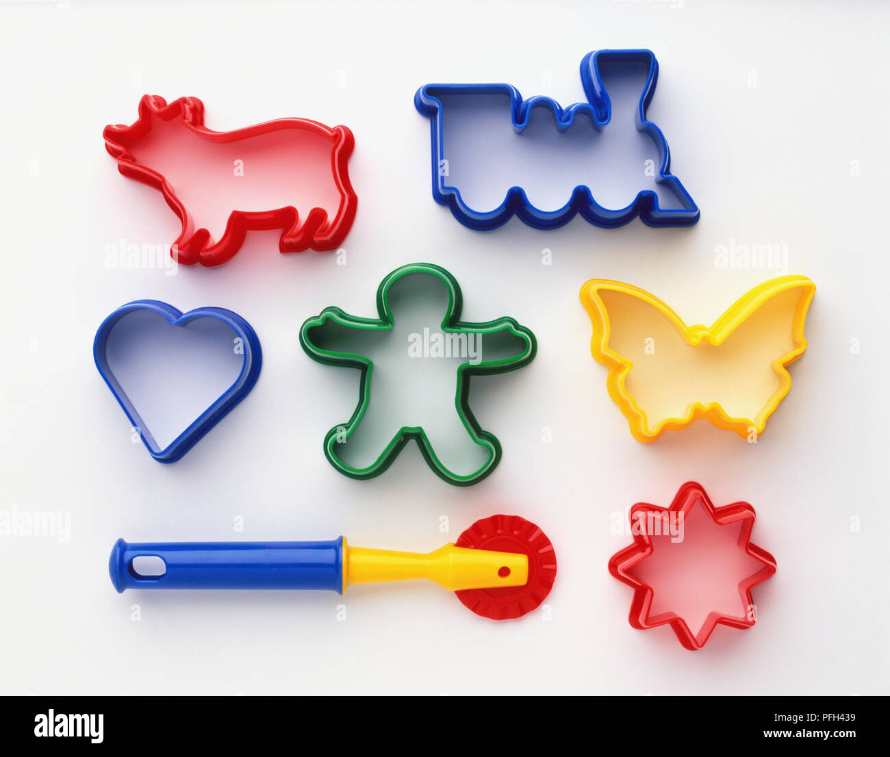 Red, green, yellow and blue biscuit cutters, including heart, star ...