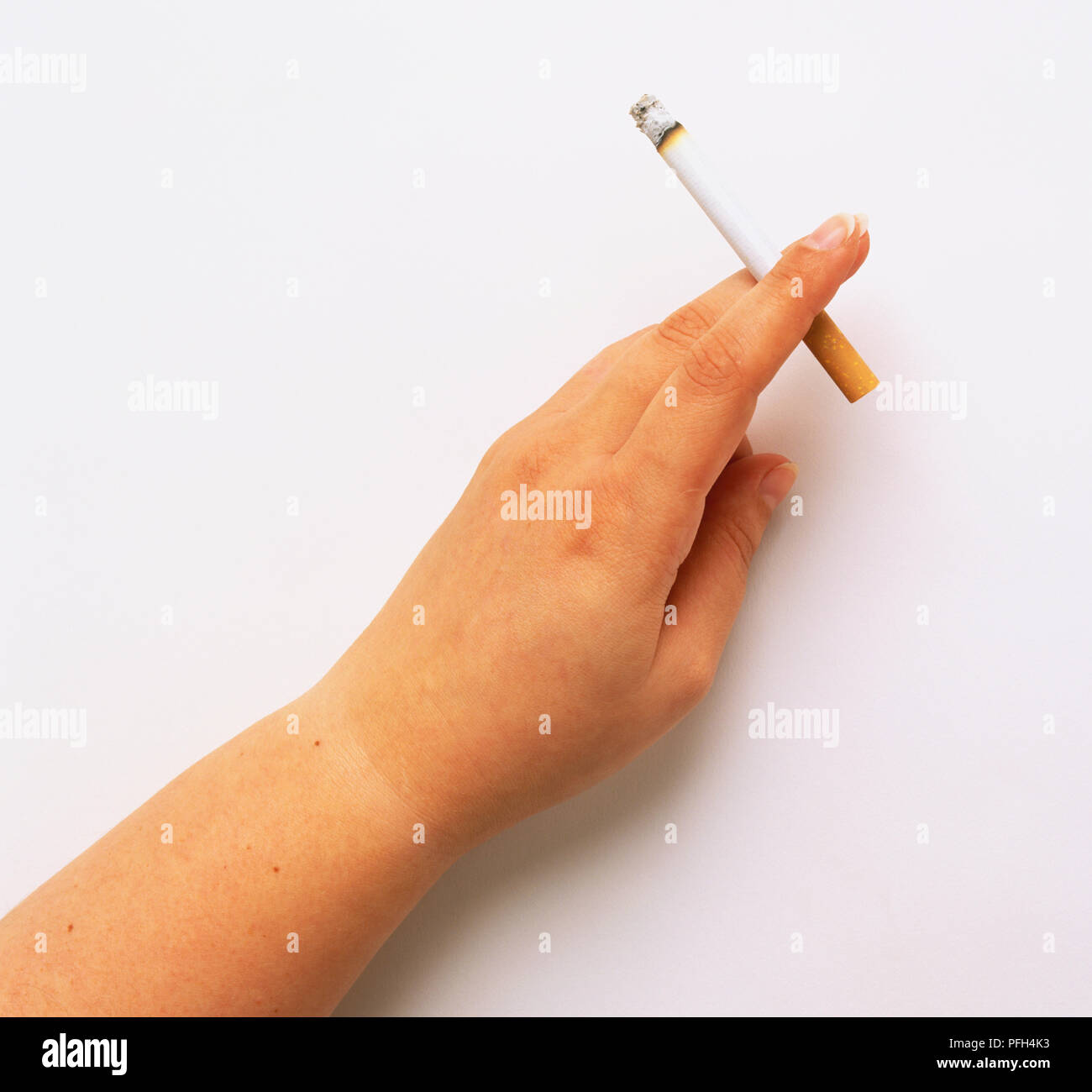 Hand holding a filter cigarette Stock Photo - Alamy