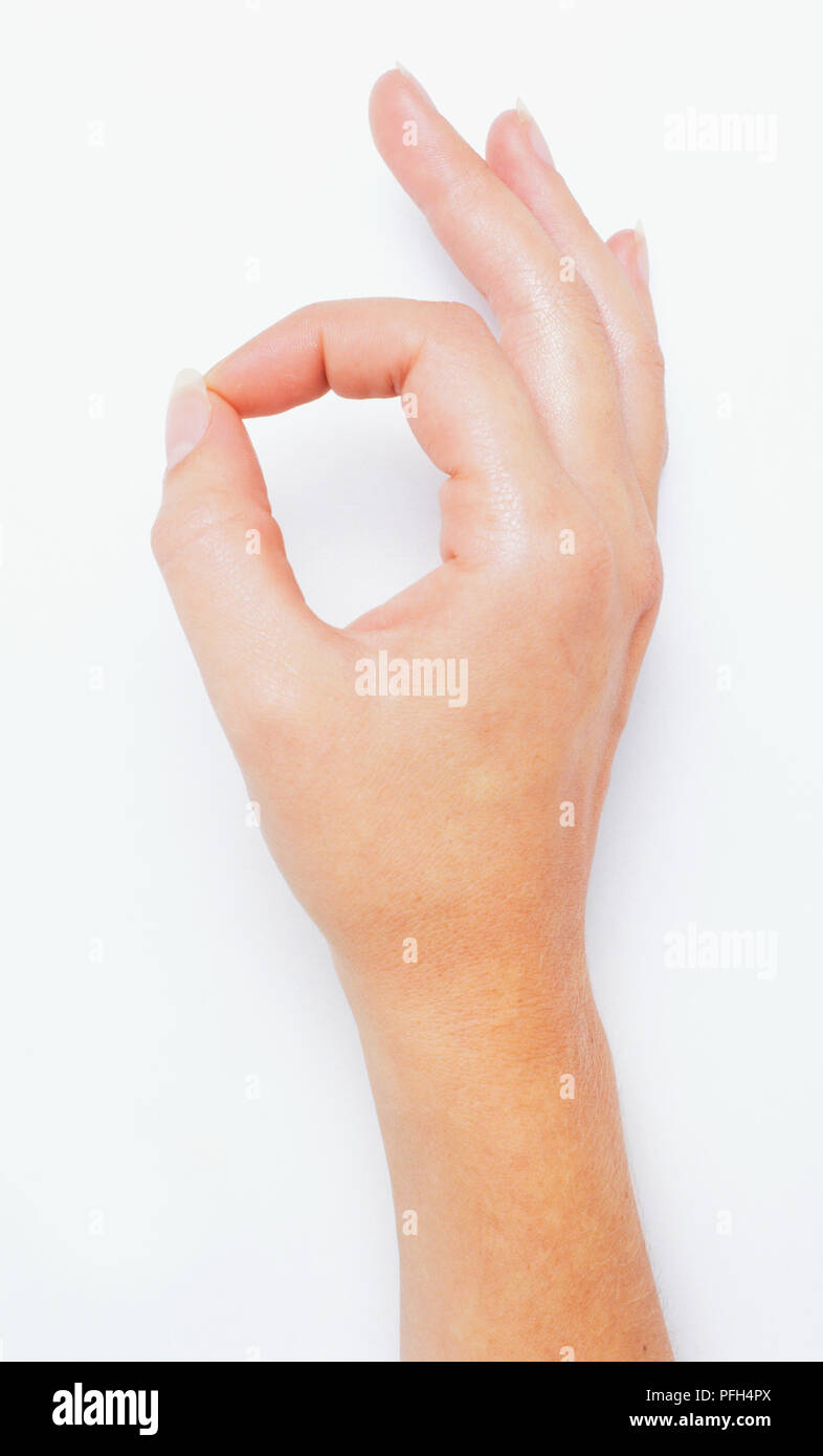 Woman's hand making 'ok' sign Stock Photo - Alamy