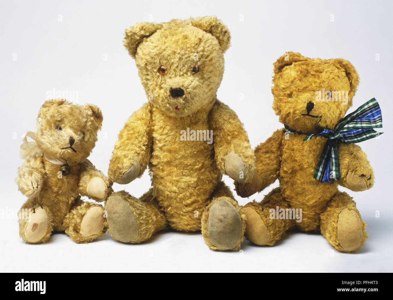 Three teddy bears sat side by side, front view Stock Photo - Alamy