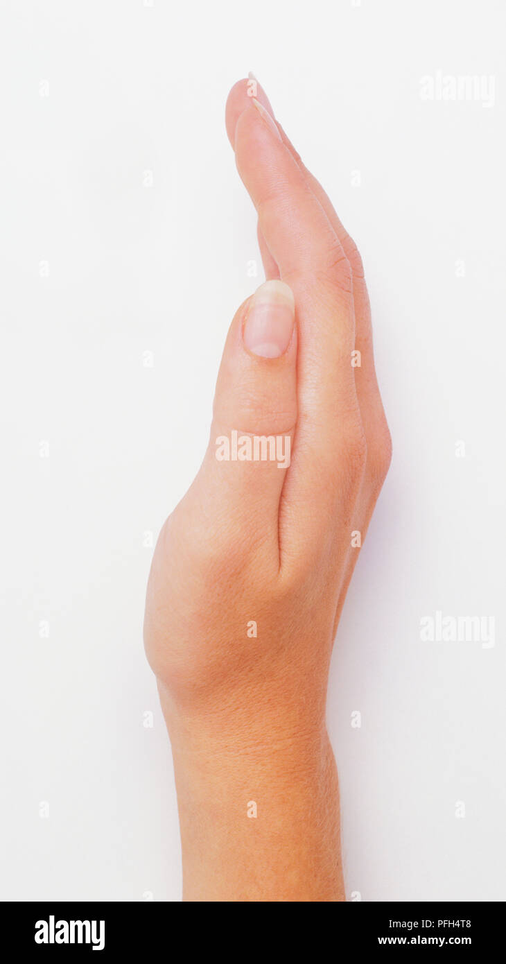 A woman's hand, side view with thumb in foreground Stock Photo - Alamy