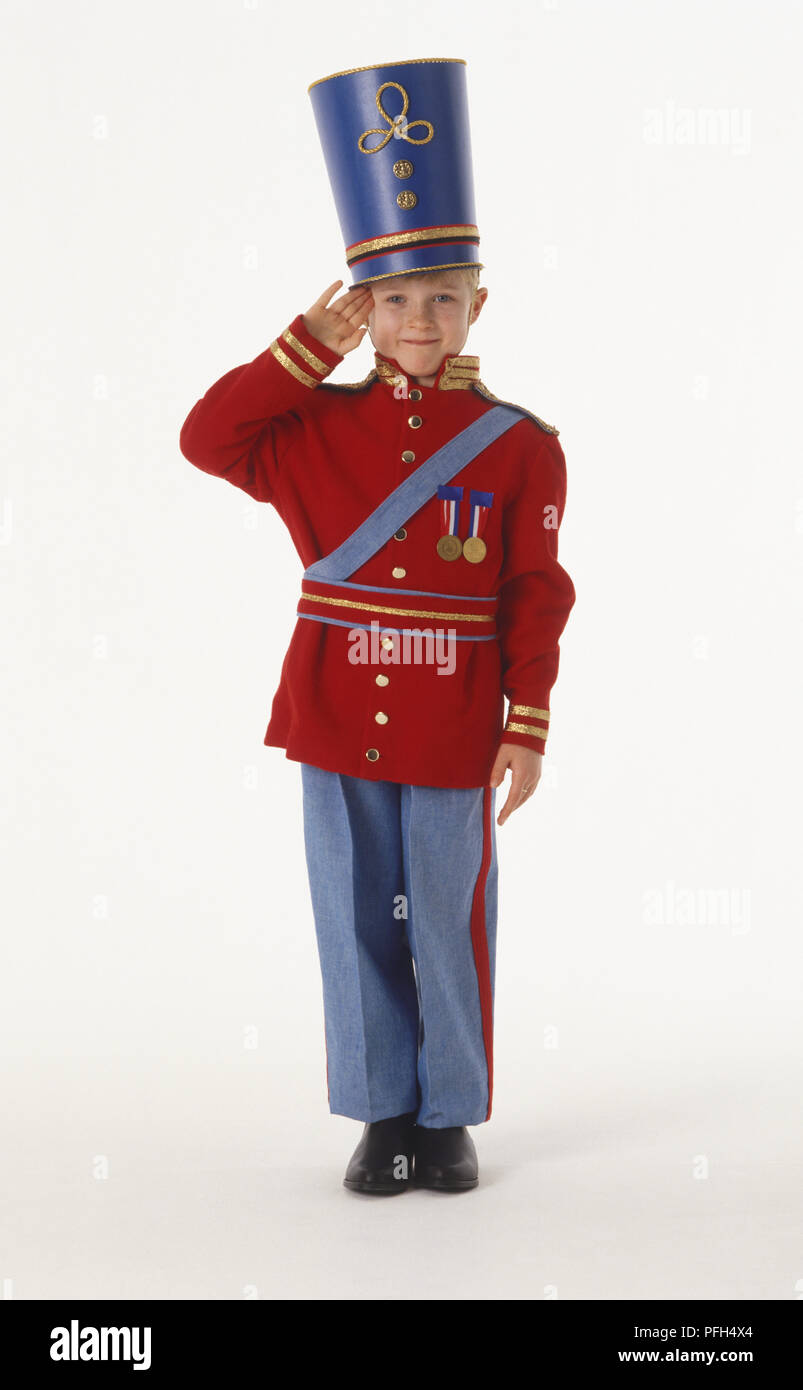 Boy in solider costume saluting, front view Stock Photo - Alamy