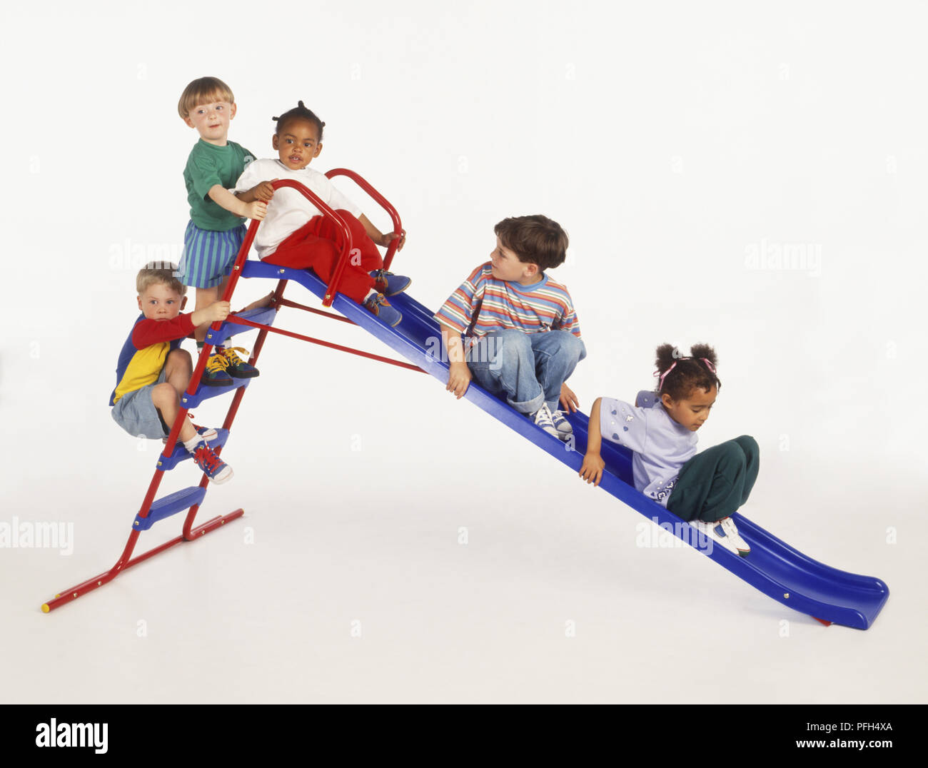 Group of children on a slide, side view hi-res stock photography and ...