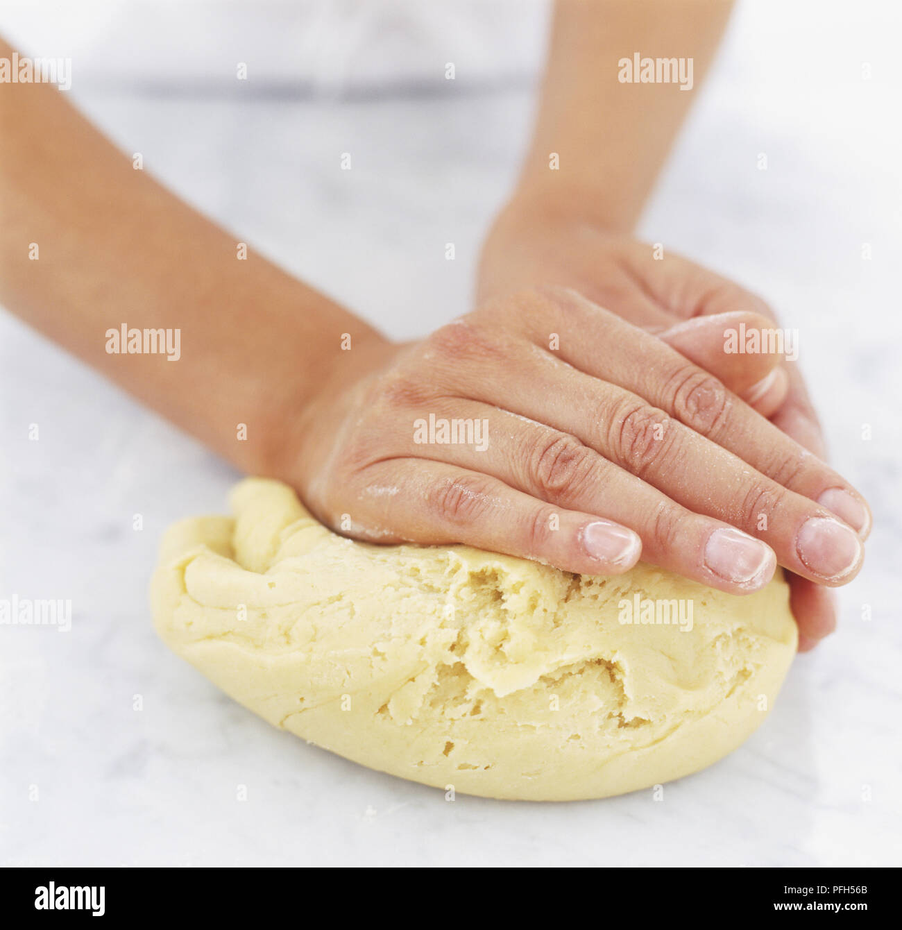 Using hands to knead dough, close up Stock Photo - Alamy