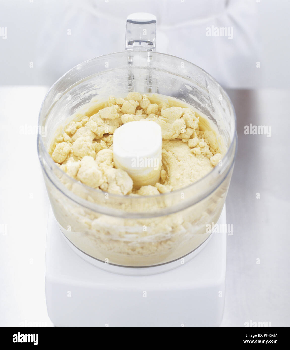 Mixture of eggs, butter, sugar and flour in a food processor, high ...