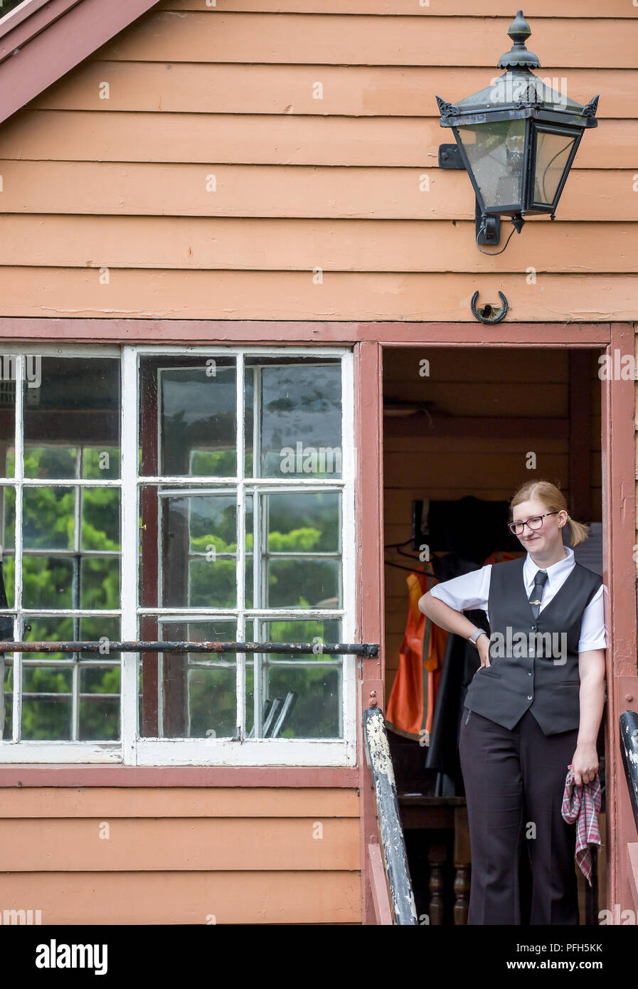 Female signalman standing enjoying sunshine in doorway of railway ...