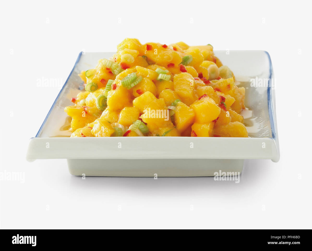 Mango-ginger relish in square shaped serving dish Stock Photo - Alamy