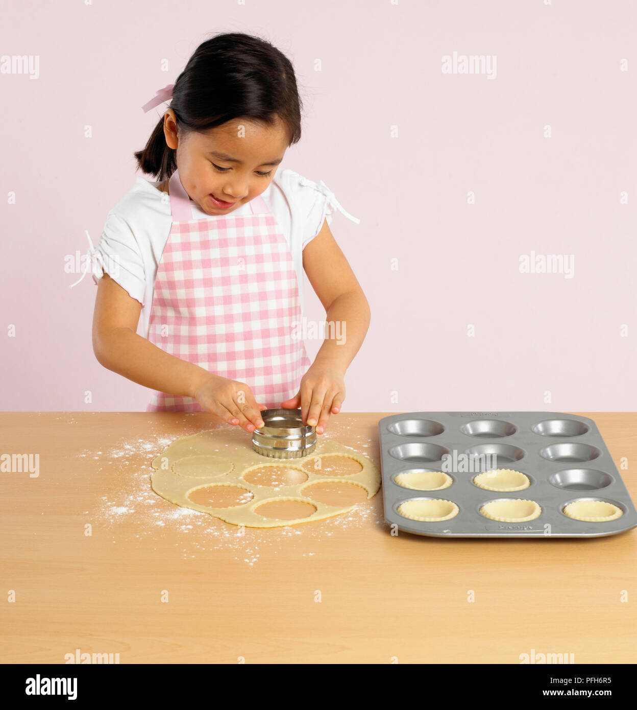 Girl cutting dough using pastry cutter Stock Photo - Alamy