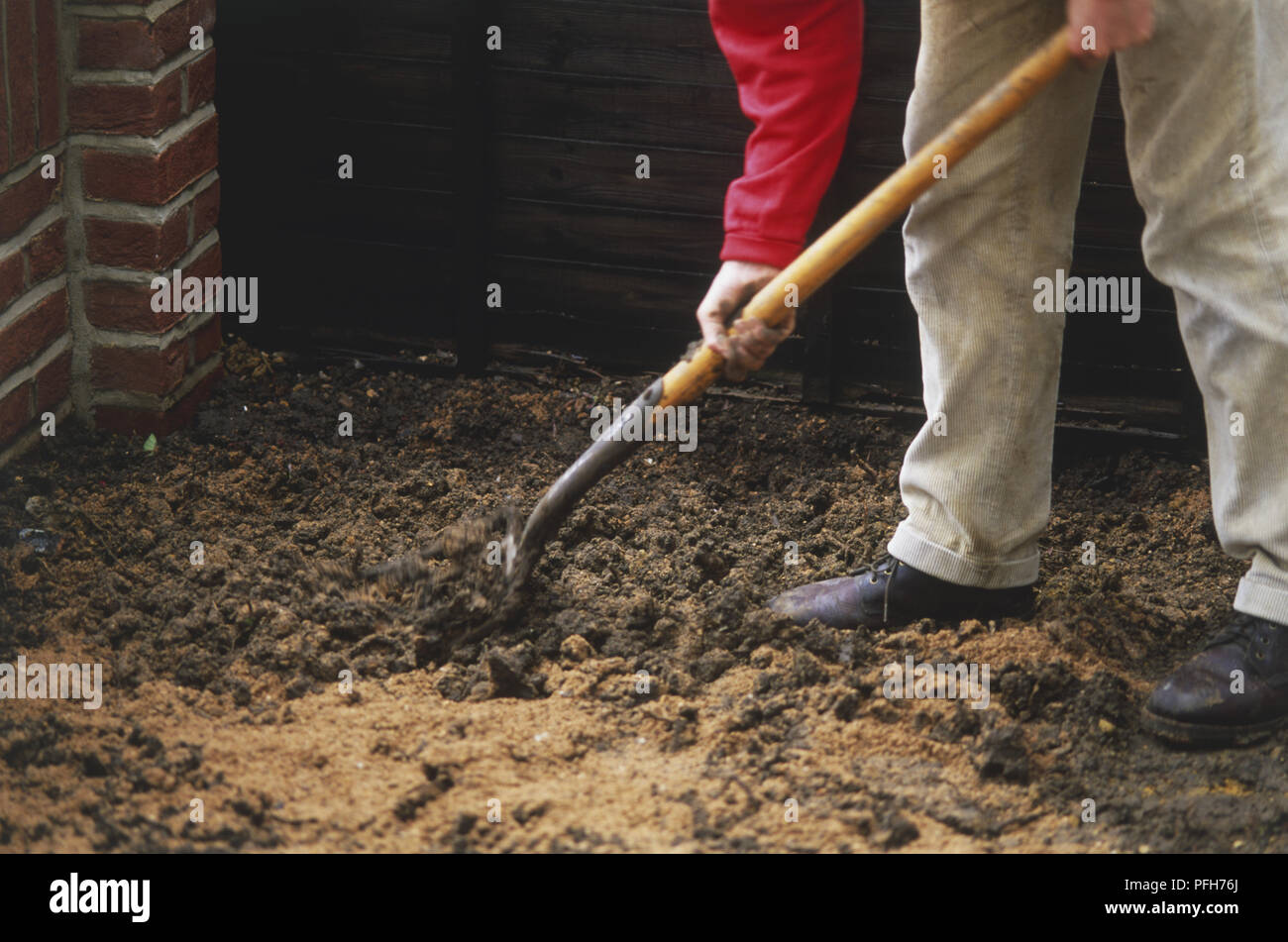 Spade in soil, digging in compost and sand, side view Stock Photo - Alamy