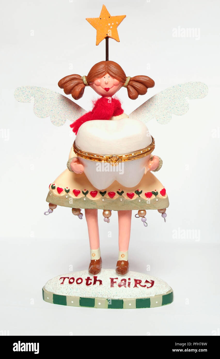 Tooth fairy figurine holding tooth-shaped box Stock Photo - Alamy