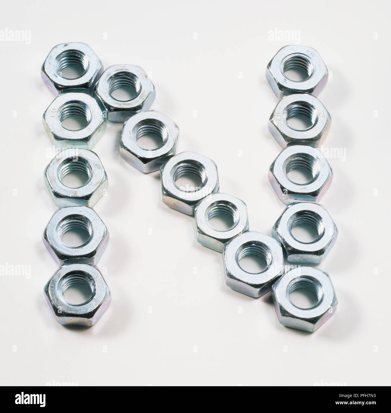 Screw nuts arranged in shape of letter 'N' Stock Photo - Alamy
