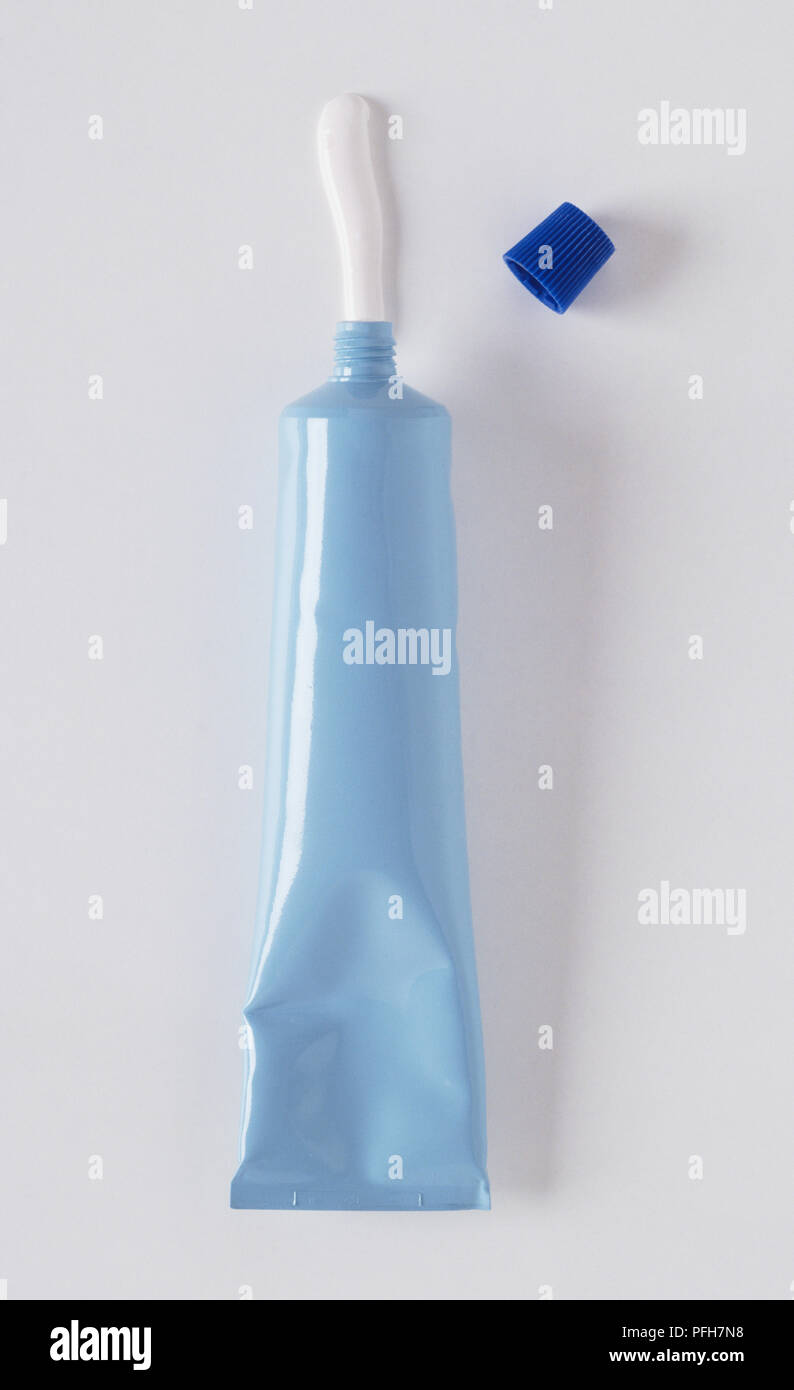White toothpaste spilling out of blue tube Stock Photo - Alamy