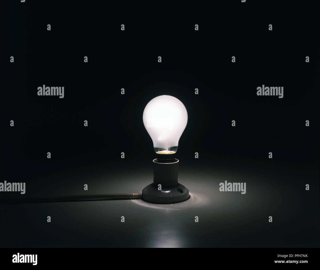 A light bulb turned on, black background Stock Photo - Alamy