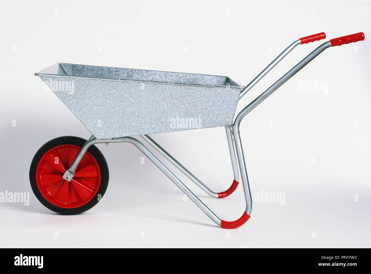 Wheelbarrow with red wheel and red handles, side view Stock Photo - Alamy