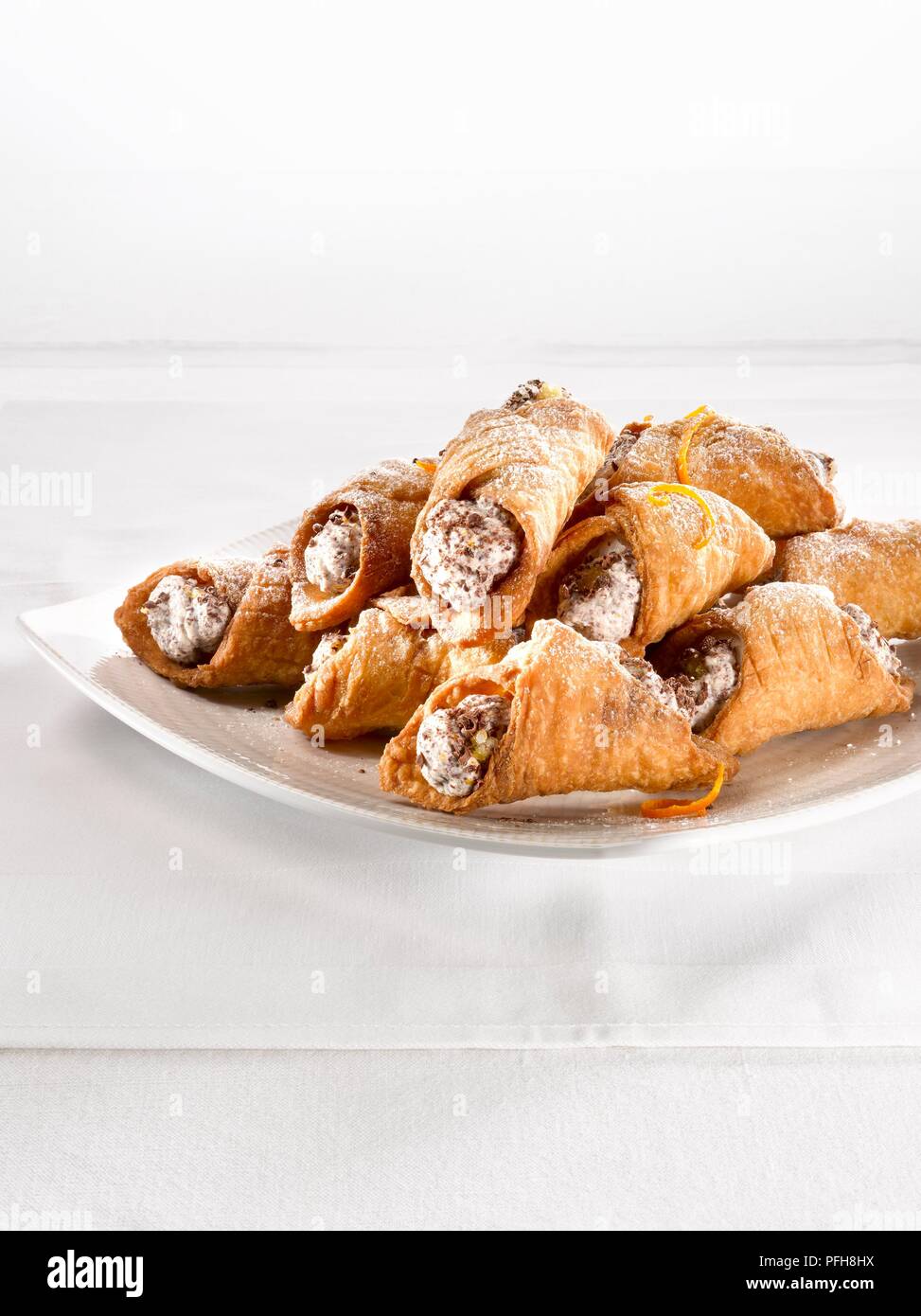 Cannoli filled with dark chocolate, ricotta cheese and citrus peel, on ...