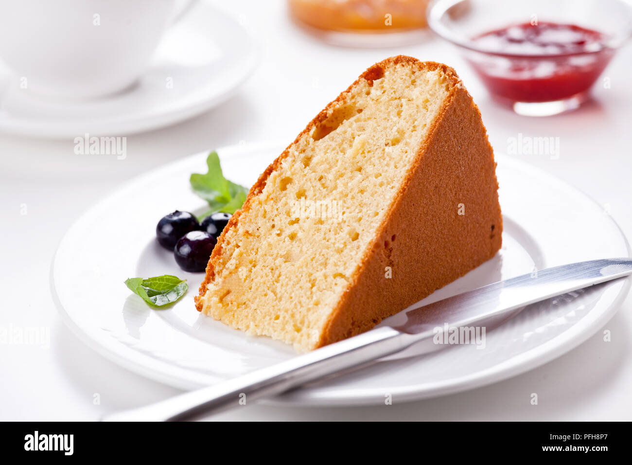 Slice of a homemade vanilla cake for breakfast Stock Photo - Alamy