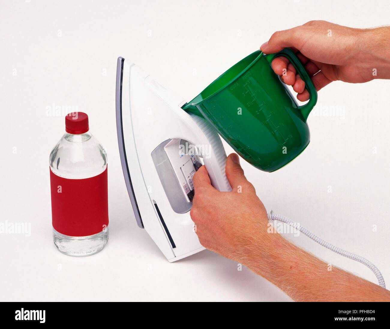Water poured into steam iron, close-up Stock Photo - Alamy