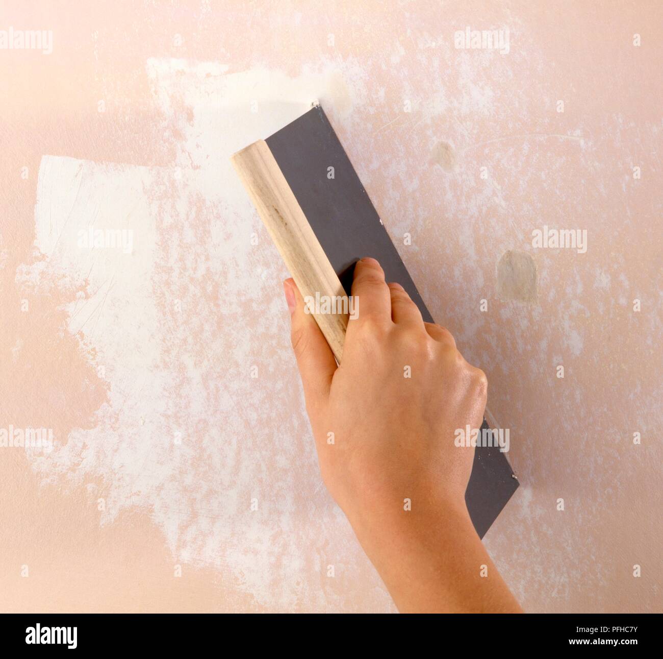 Caulking blade being used to spread filler, close-up Stock Photo - Alamy