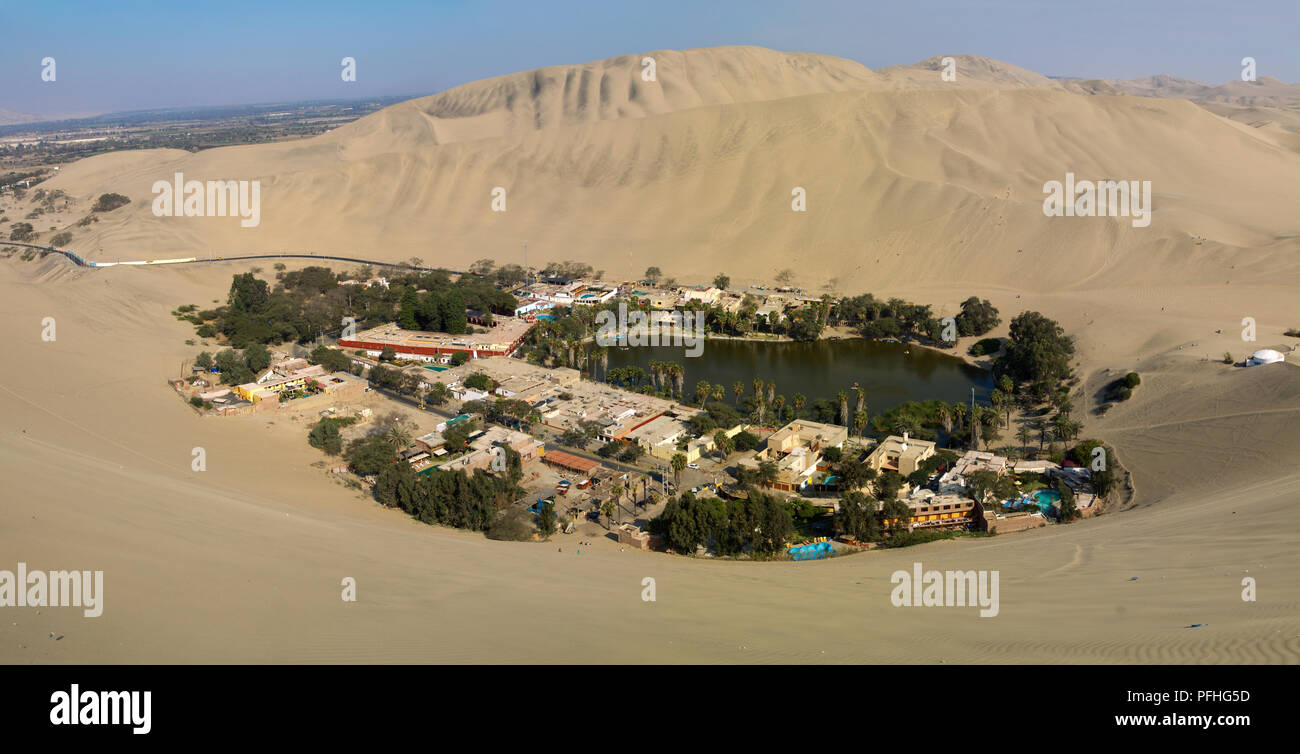 Huacachina oasis landscape panorama. Windy and sand over the air. Ica ...