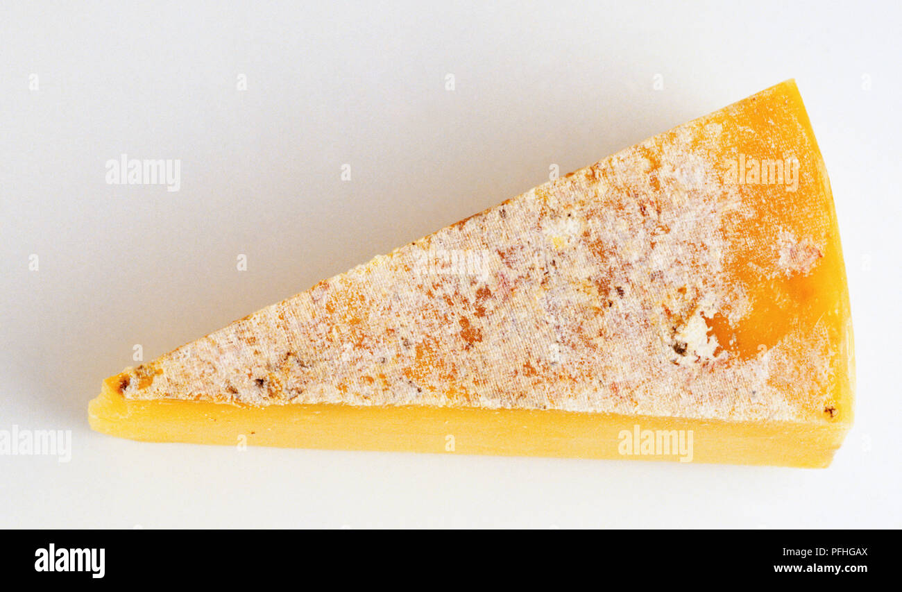 A wedge of fresh hard cheese Stock Photo - Alamy