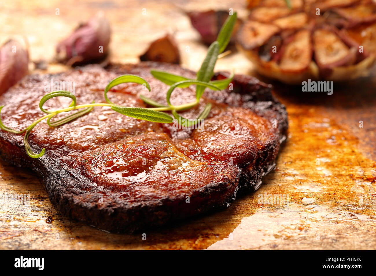Fried grilled pork neck with garlic on rustic background Stock Photo ...