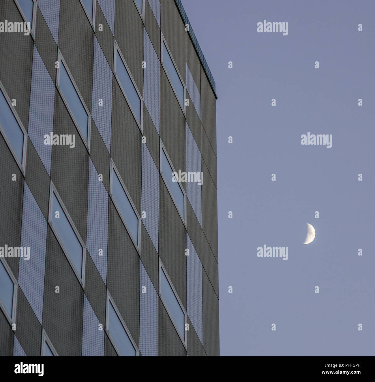 Side view of modern skyscraper with crescent moon Stock Photo - Alamy