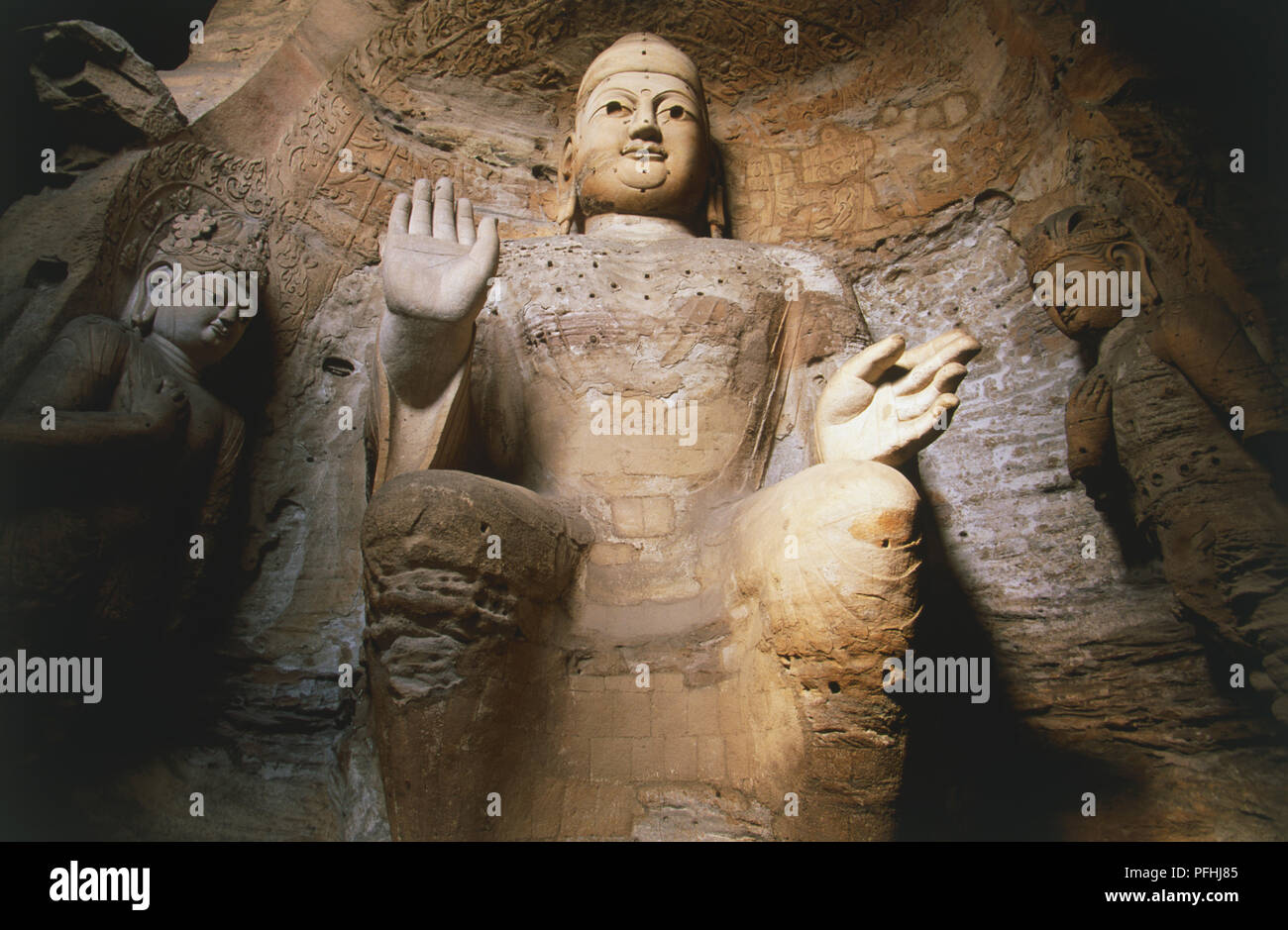 China, Shanxi, Yungang Caves, Cave 3, Buddha statue carved into the ...