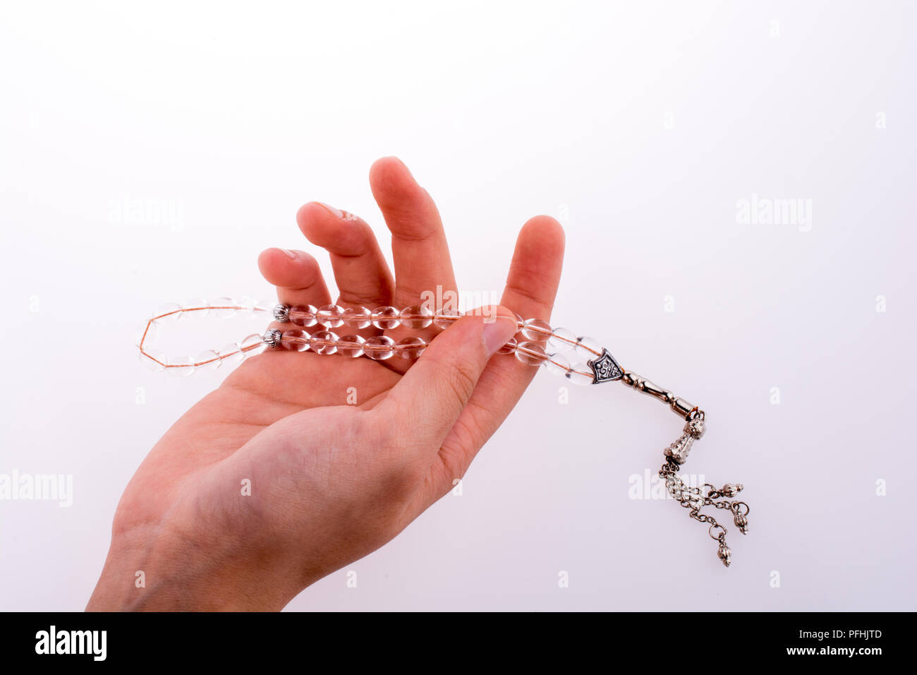 Hand holding a tespih on a white background Stock Photo - Alamy