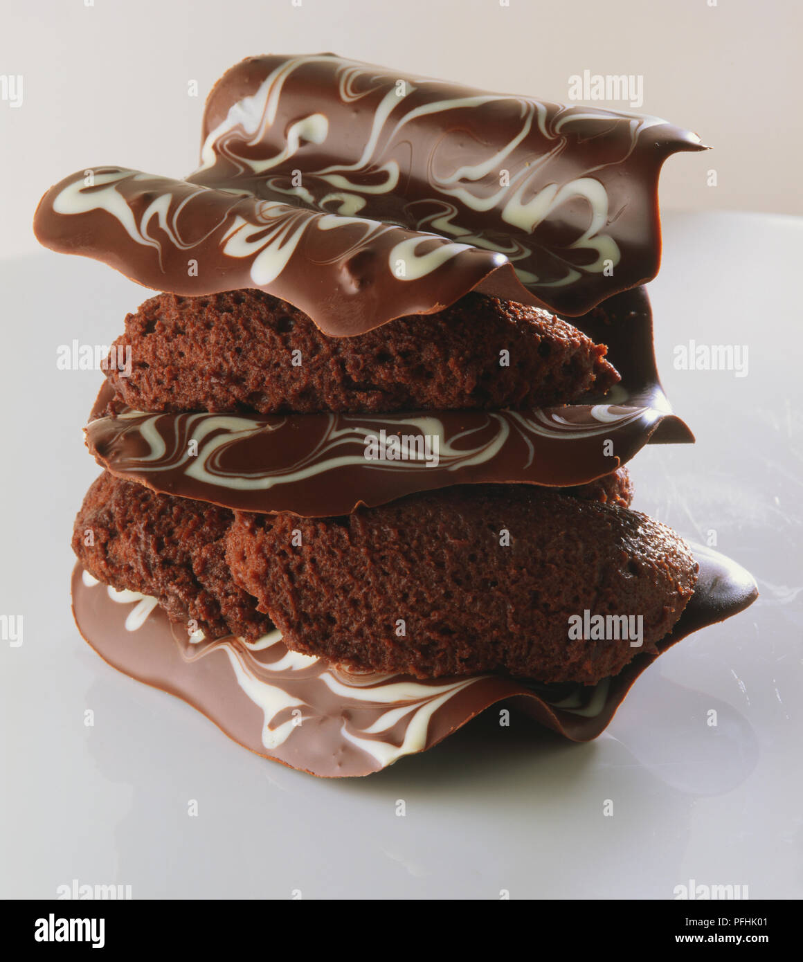 Layers of marbled milk and white chocolate filled with chocolate mousse ...