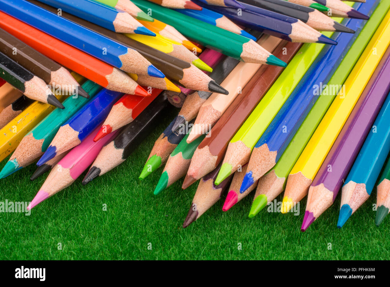 Color pencils scattered on green grass Stock Photo - Alamy