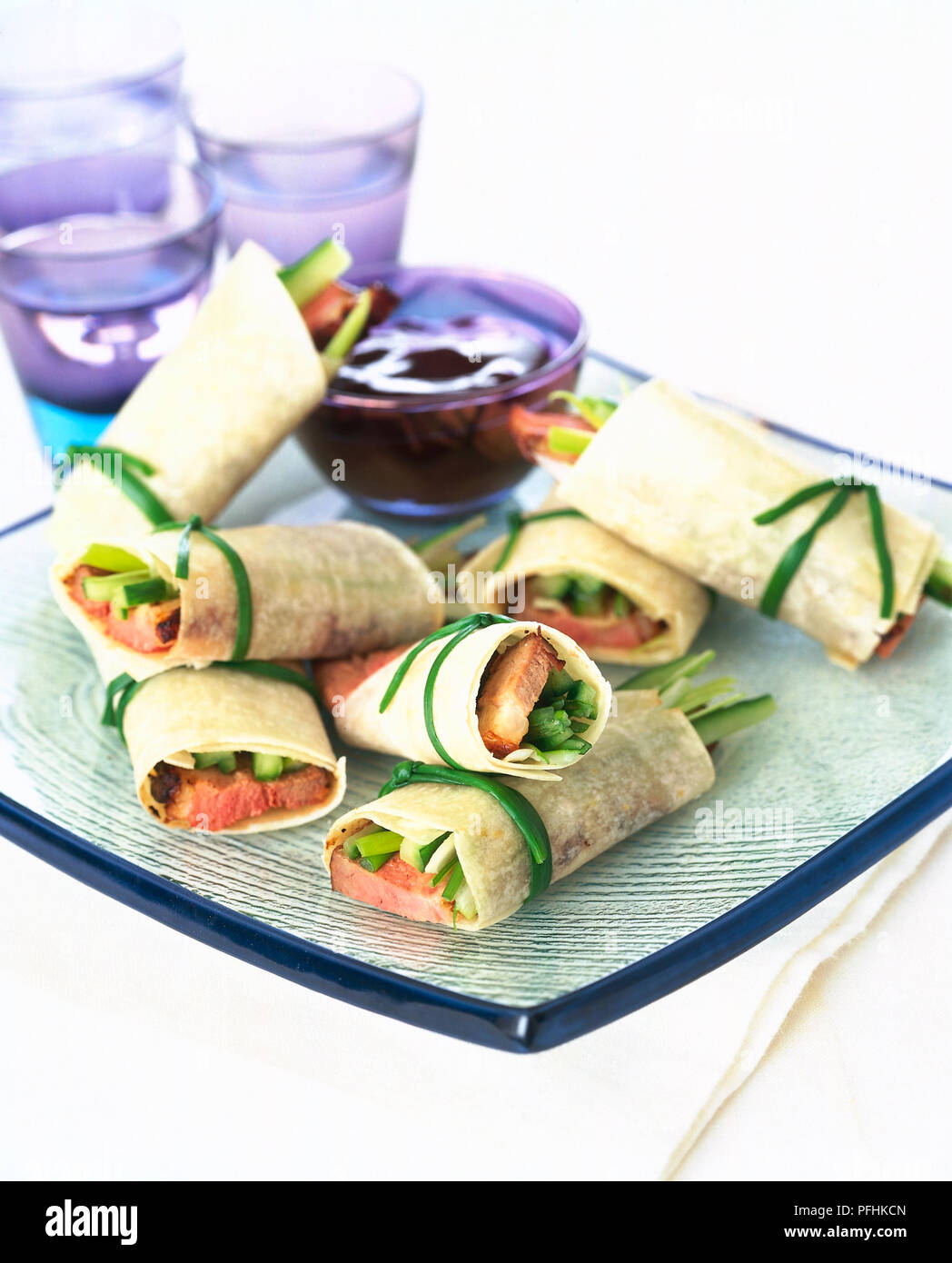 Duck rolls served with plum sauce on square tray, close up Stock Photo ...