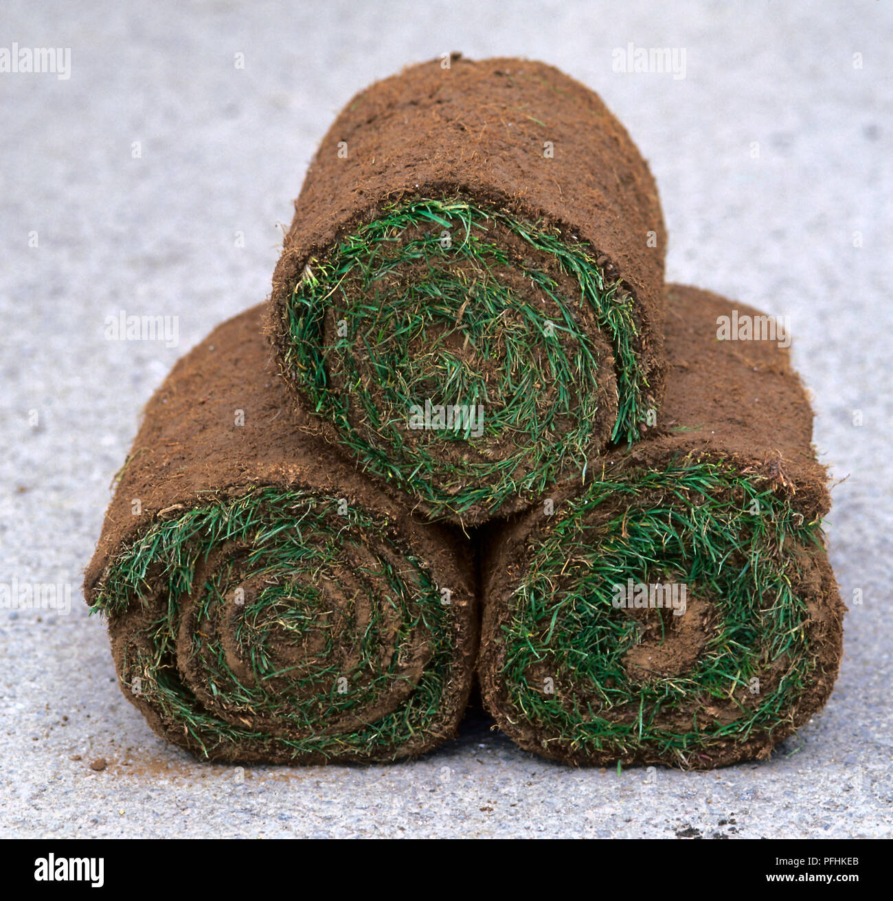 Three stacked rolls of turf, front view Stock Photo - Alamy