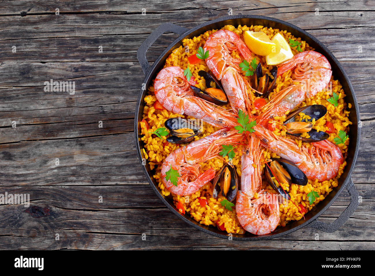 delicious seafood valencia paella with king prawns, mussels on savory ...