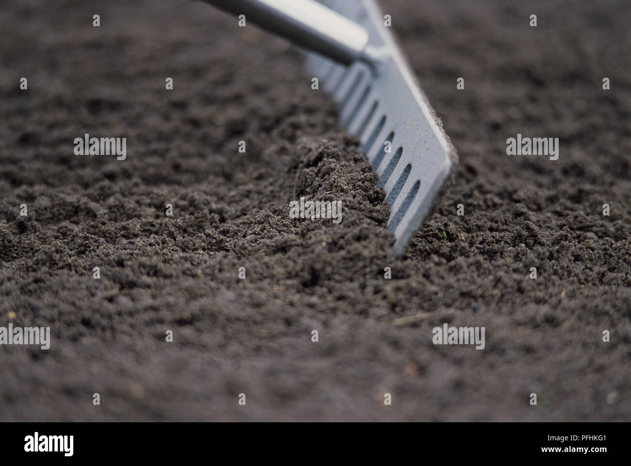 Soil being raked, side view Stock Photo - Alamy