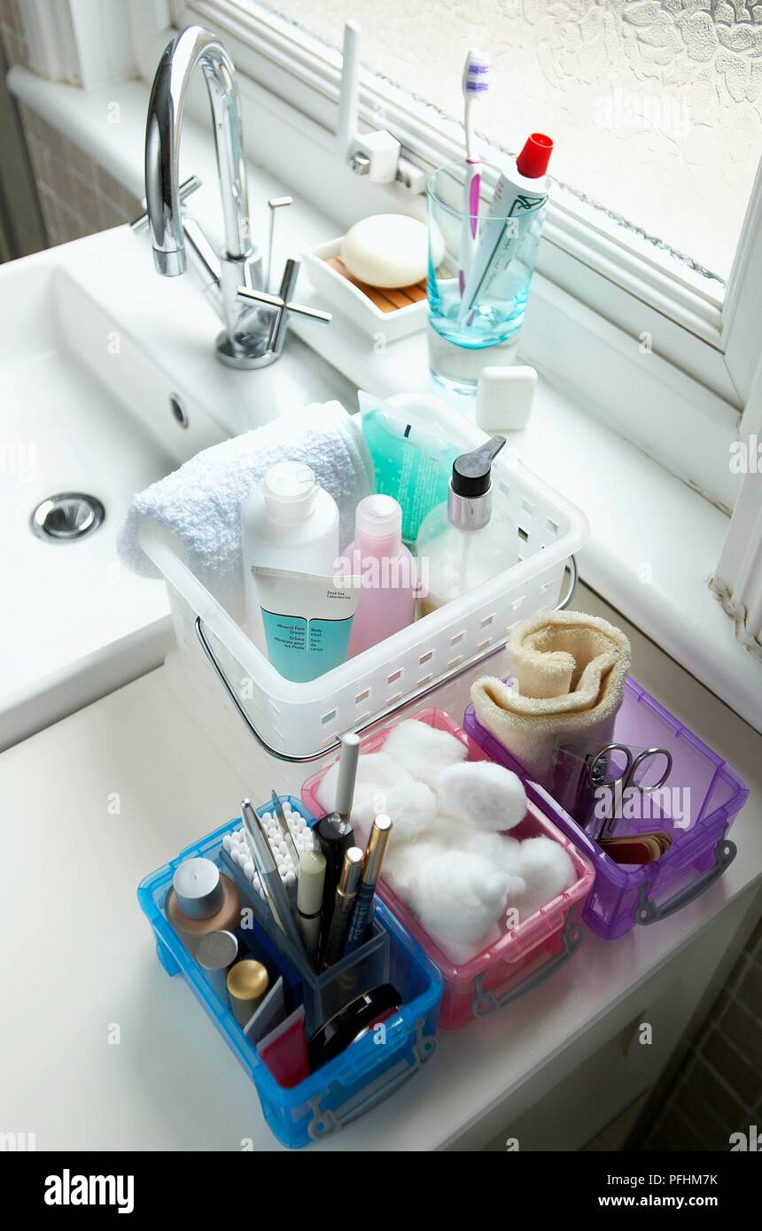 Various make-up and personal hygiene items in boxes by the side of ...