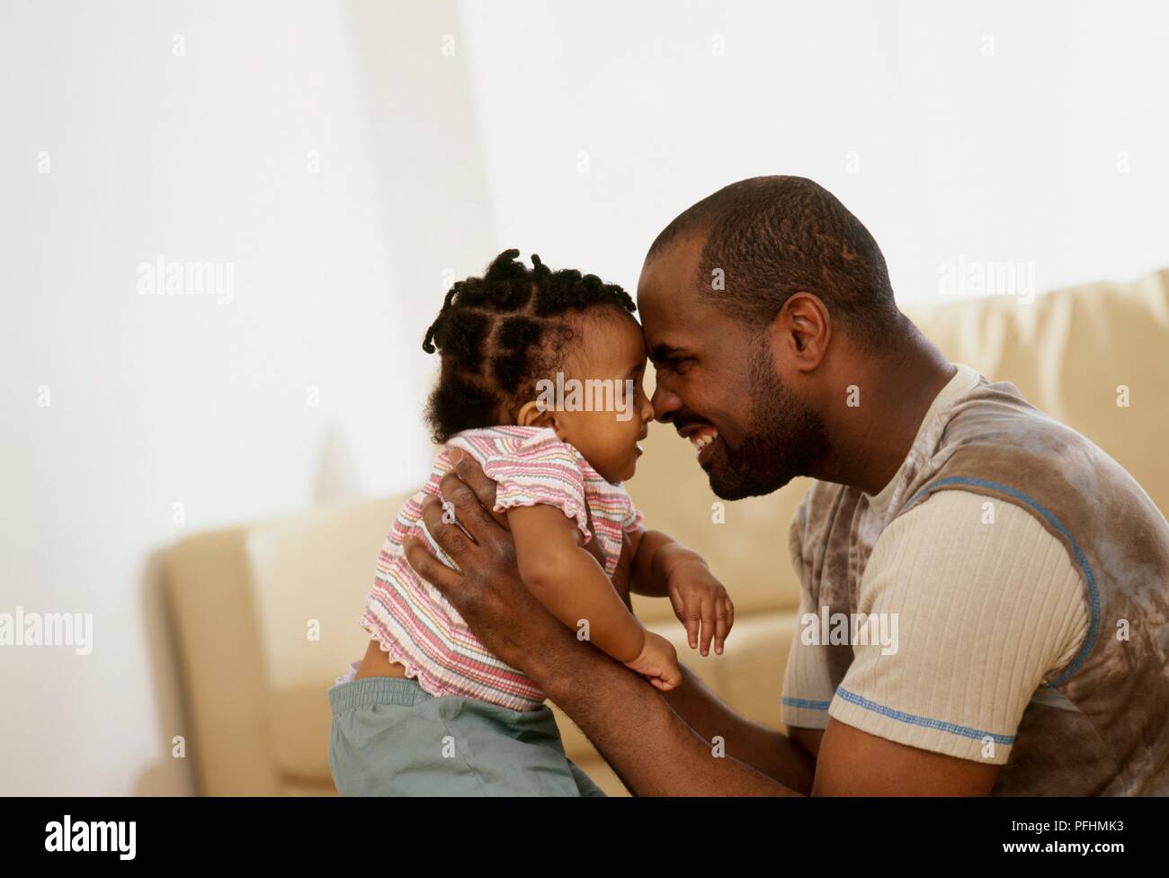 Man and baby girl rubbing noses Stock Photo - Alamy