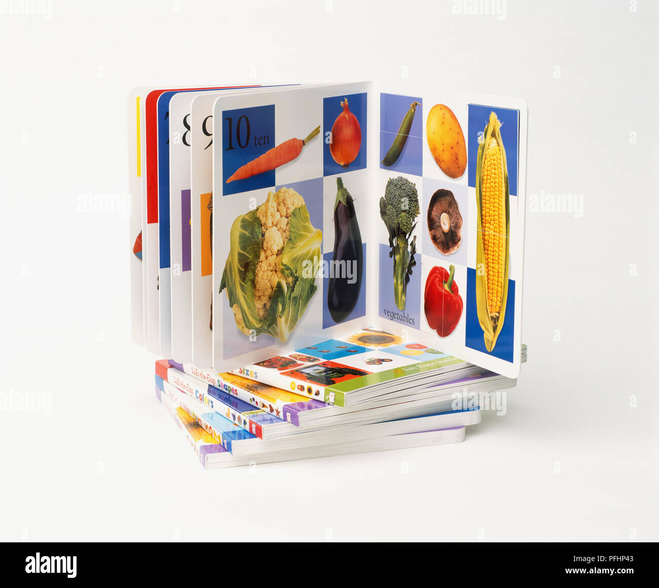 Open book standing on top of a book pile, displayed spread covered with ...