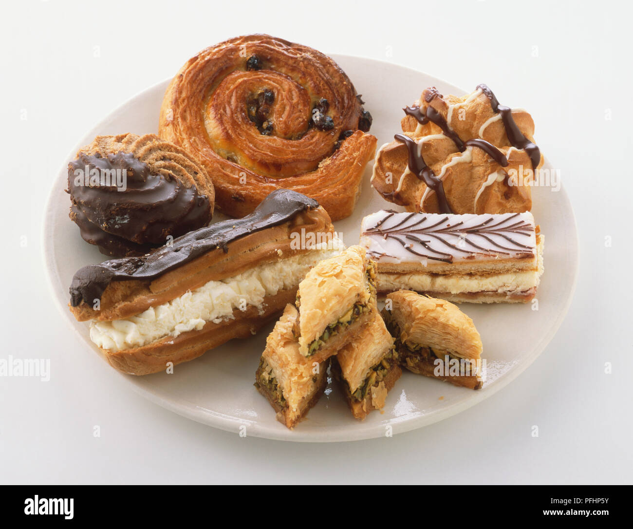 Selection of cakes and pastries on plate, close up Stock Photo - Alamy