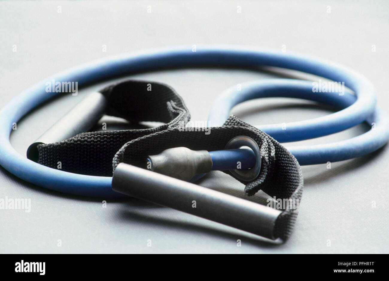 Exercise device consisting of two handles joined by rubber tubing ...