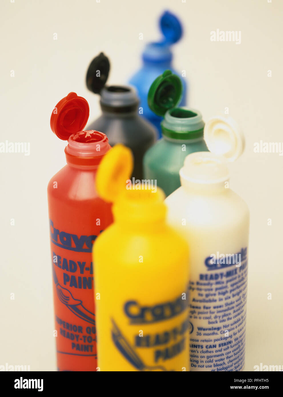 Six plastic bottles of coloured paint with open lids, close up Stock ...