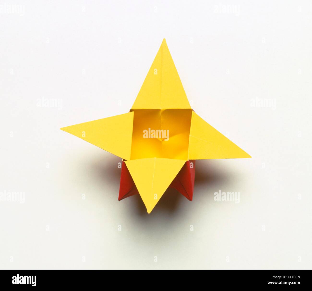 Folded paper box with four pointed flaps Stock Photo - Alamy