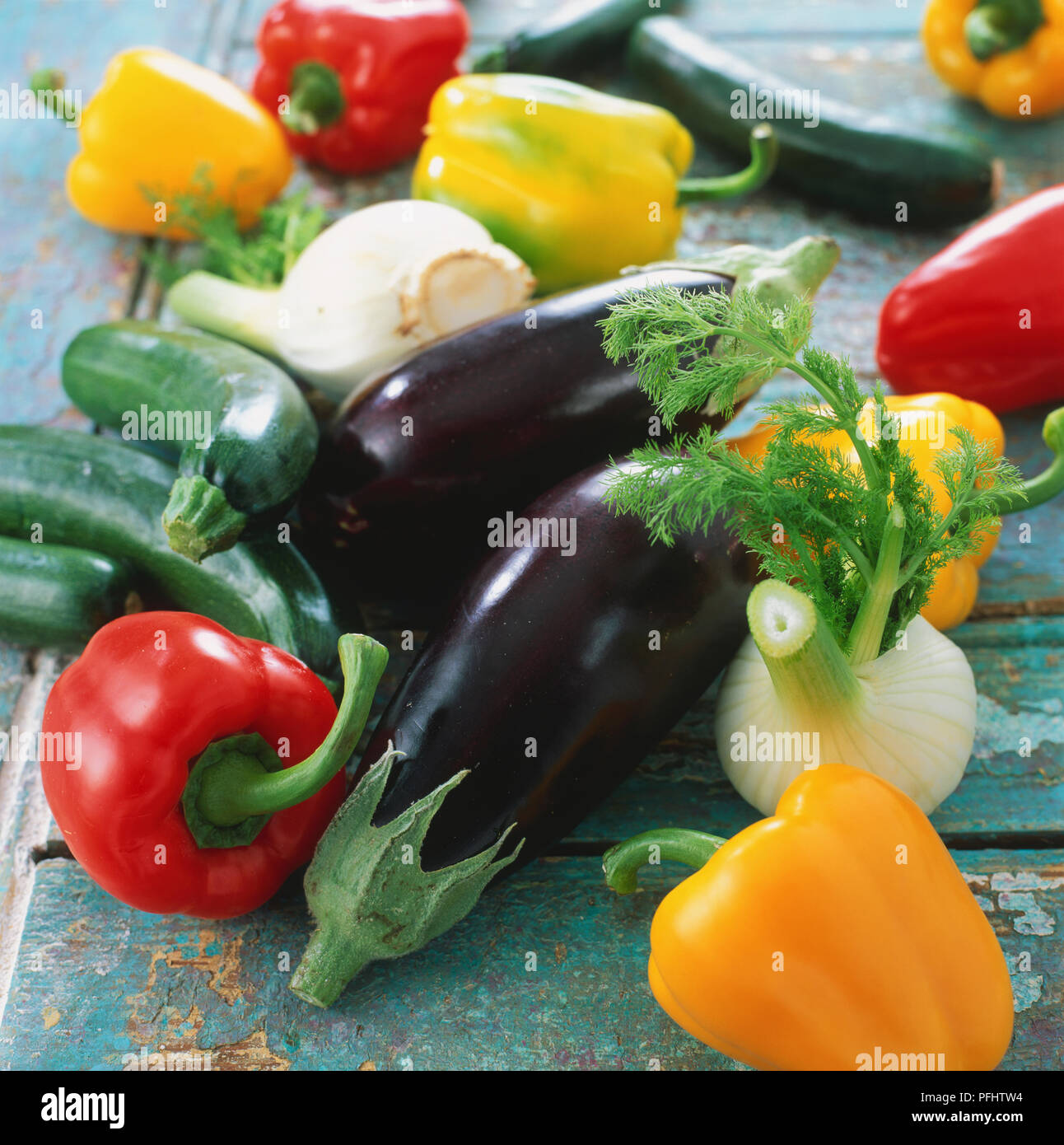 Scattered selection of fresh vegetables, aubergines, red and yellow ...