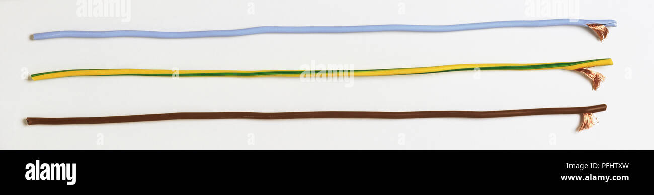 Blue, brown and green lengths of electrical wires with copper wiring ...