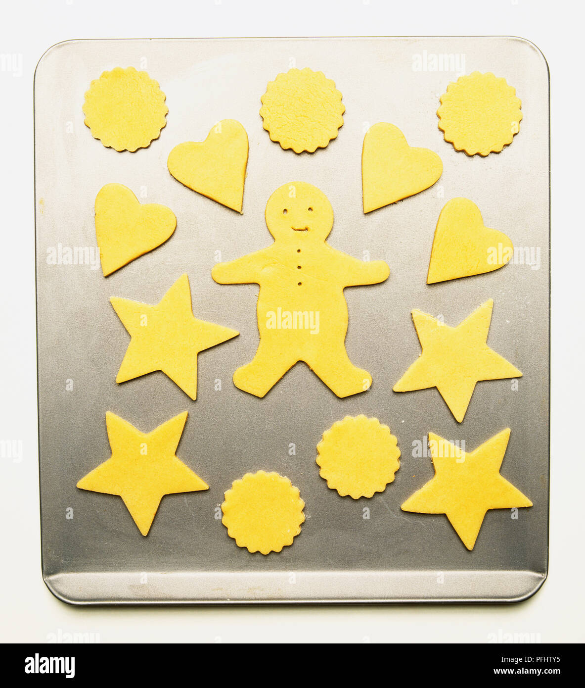 Different shaped biscuits on baking tray, uncooked Stock Photo - Alamy