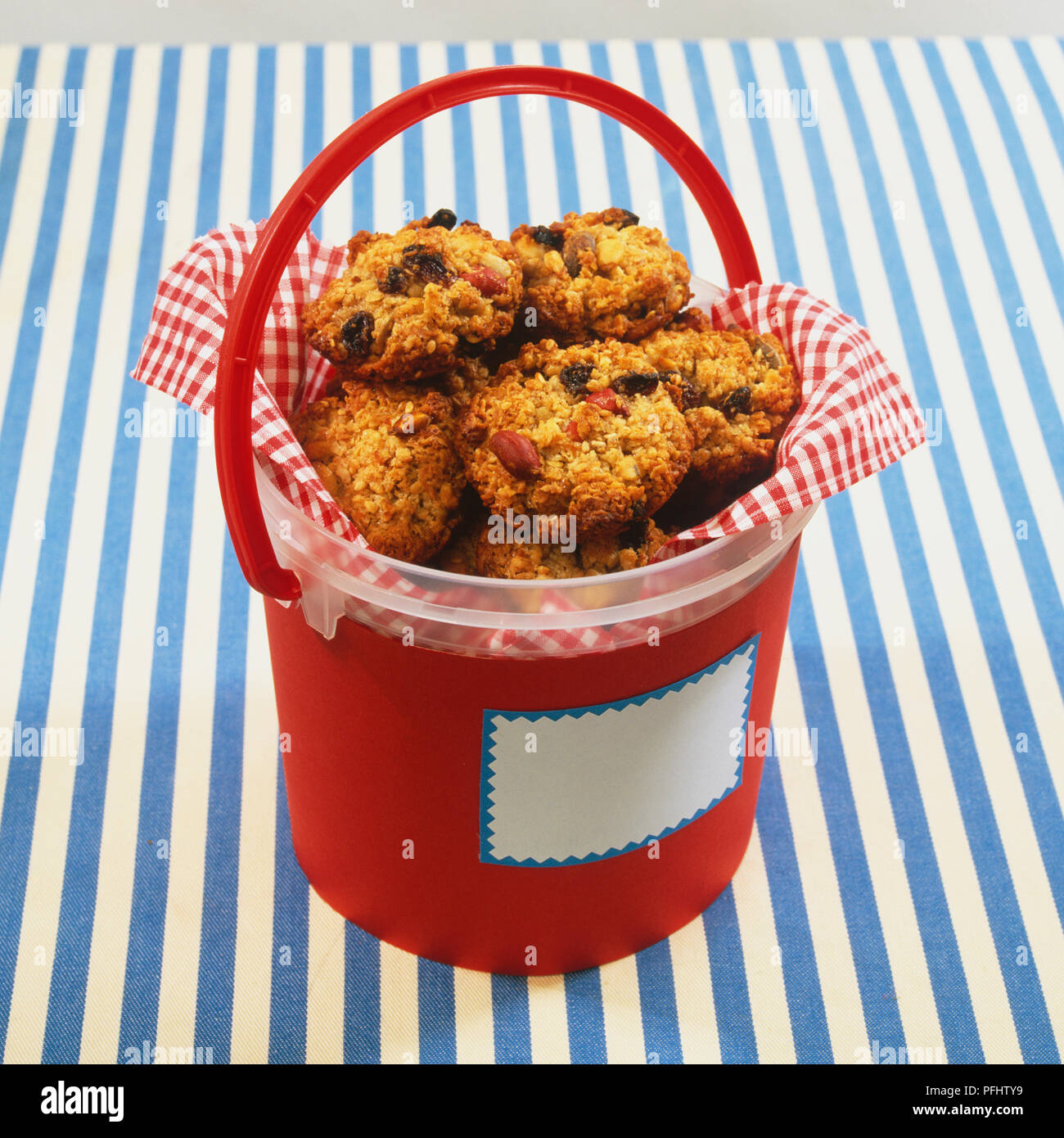 Red bucket full of chunky chocolate chip cookies, elevated view Stock ...
