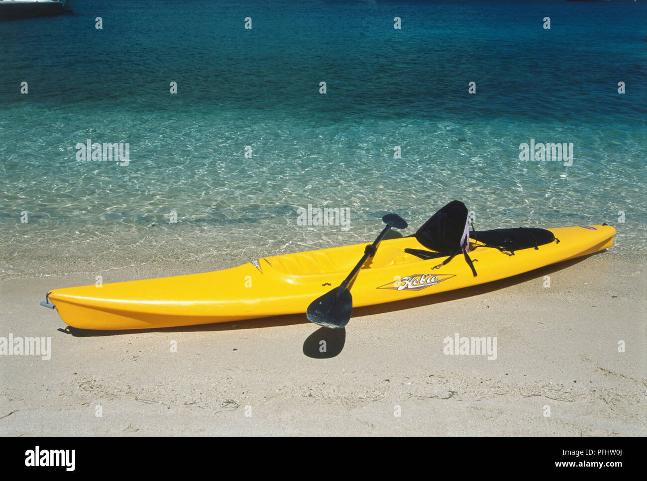 British Virgin Islands, Virgin Gorda, yellow one-seater kayak by water ...